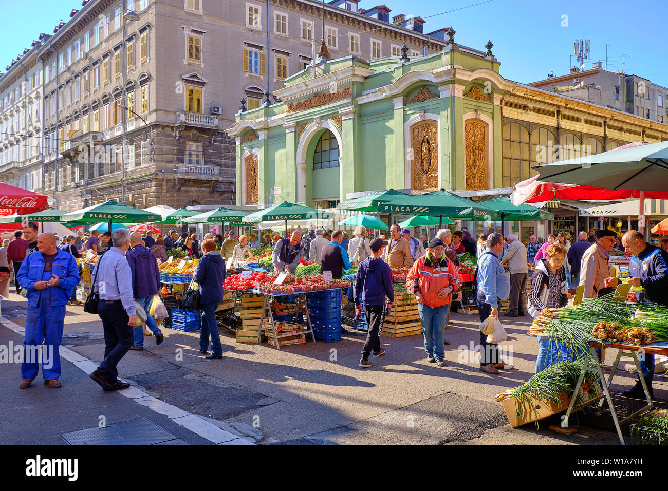 Customers walking around the outside central city market with fruit ...