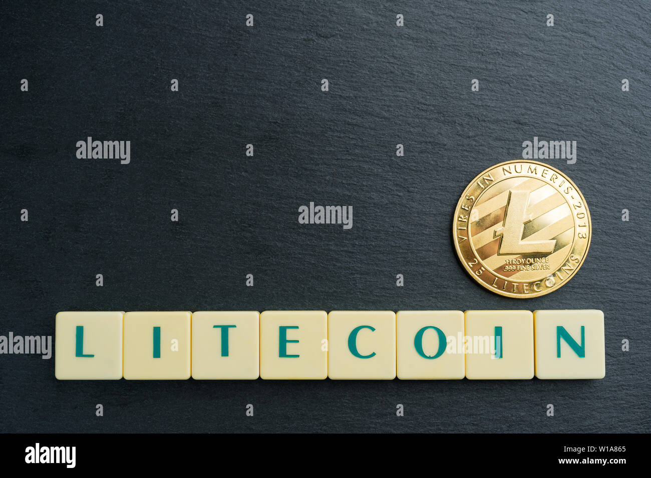 Physical Litecoin gold coin with text made out of letter tiles ...