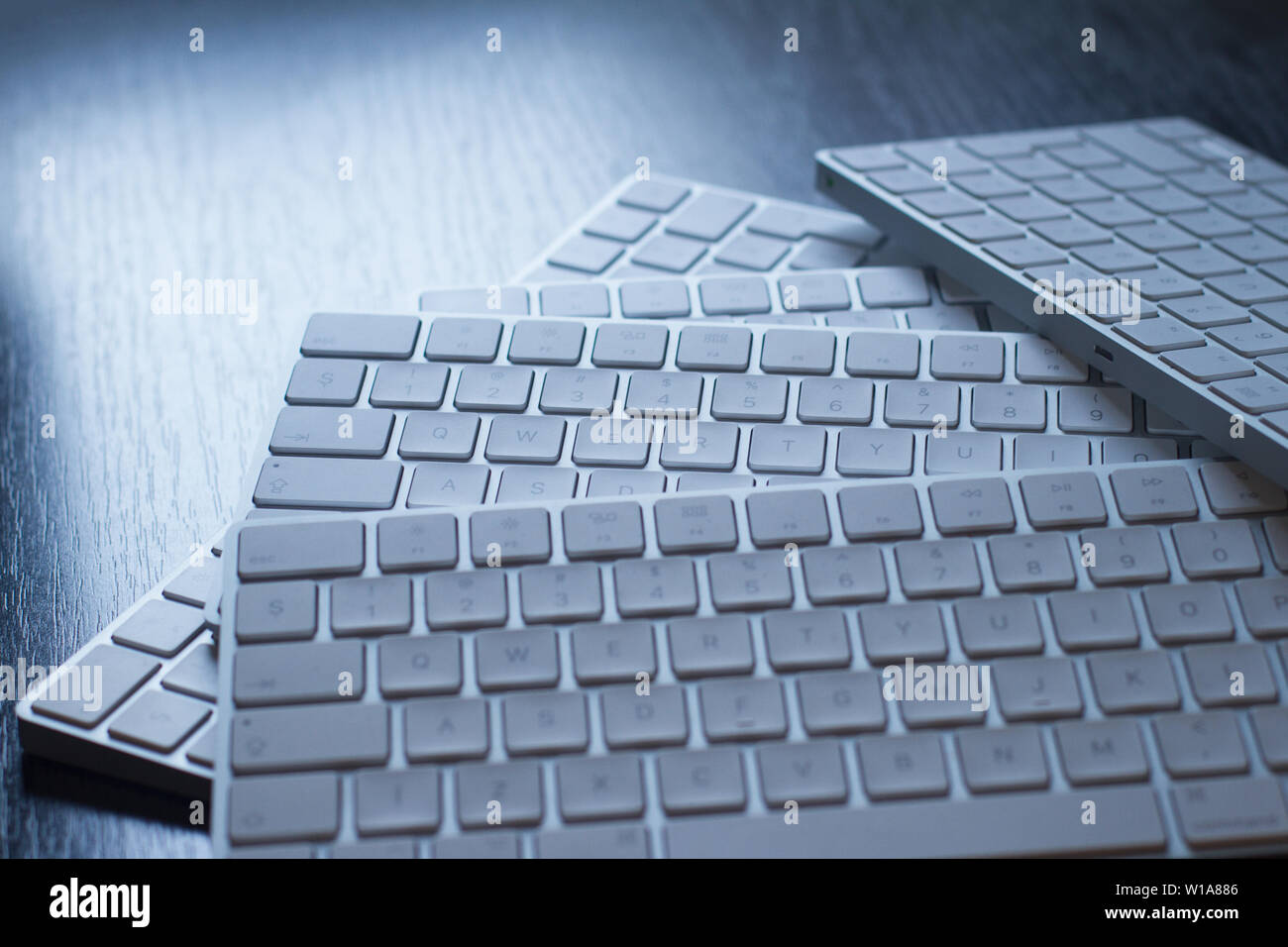 perspective view closeup of many white wireless aluminum computer ...