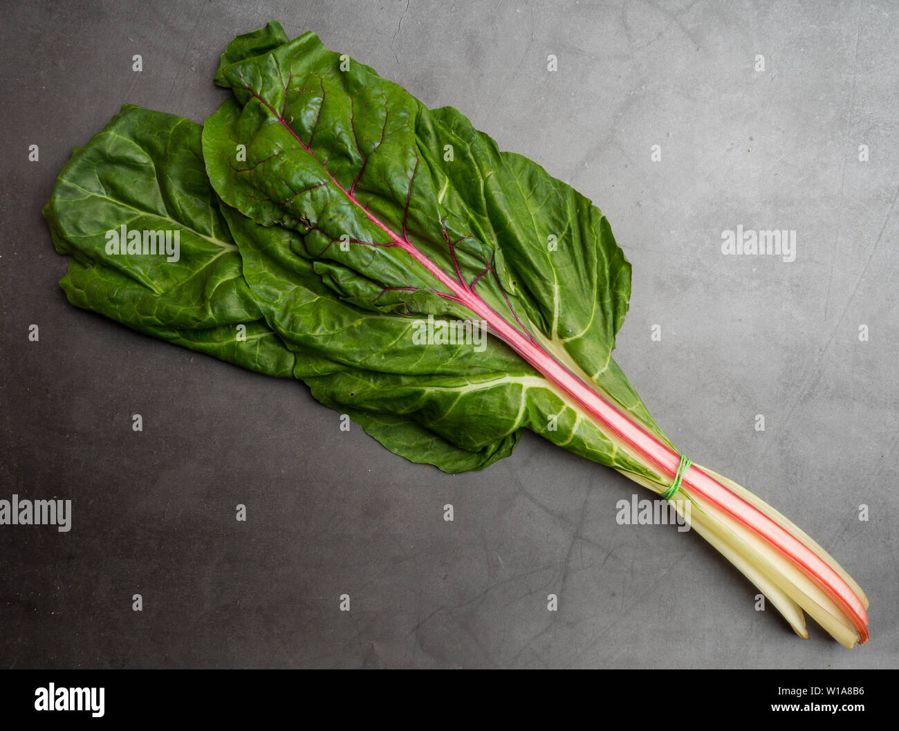 Set of fresh green chard leaves or mangold salad leaves on concrete ...