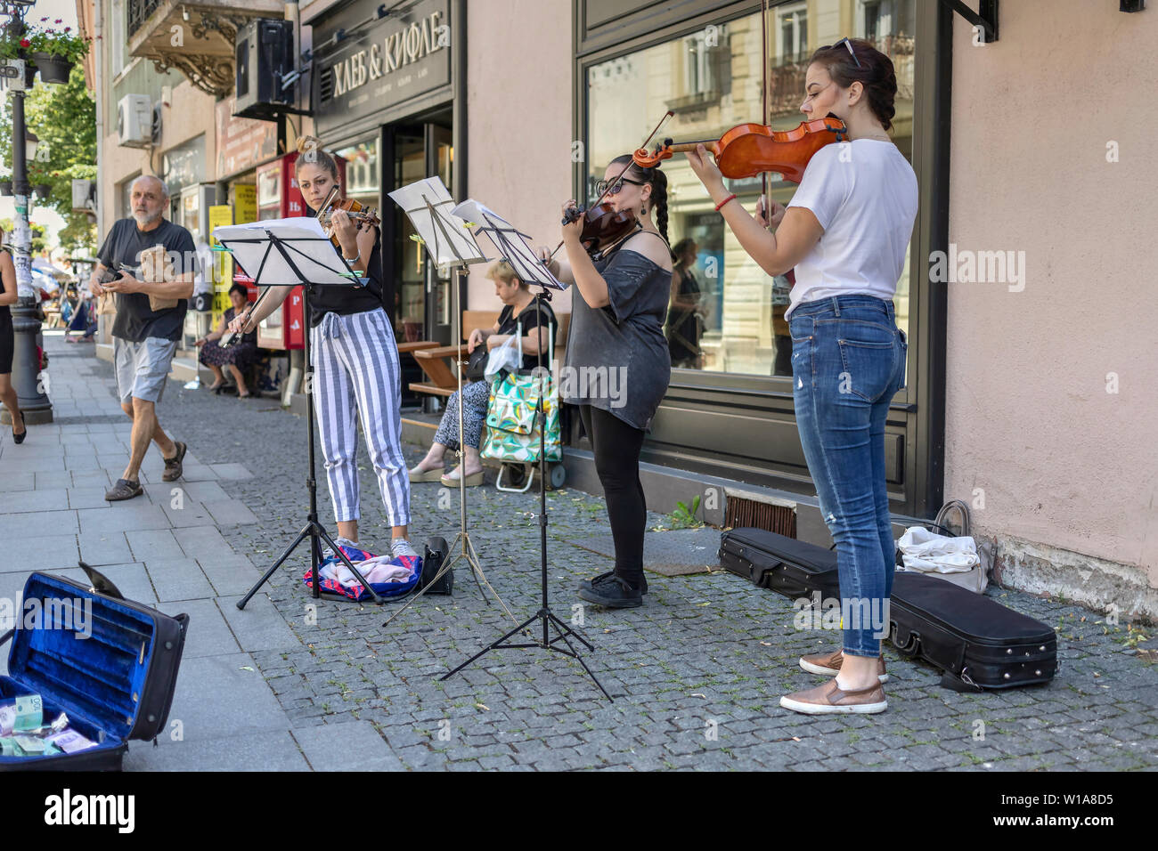 Women busking in the street hi-res stock photography and images - Alamy