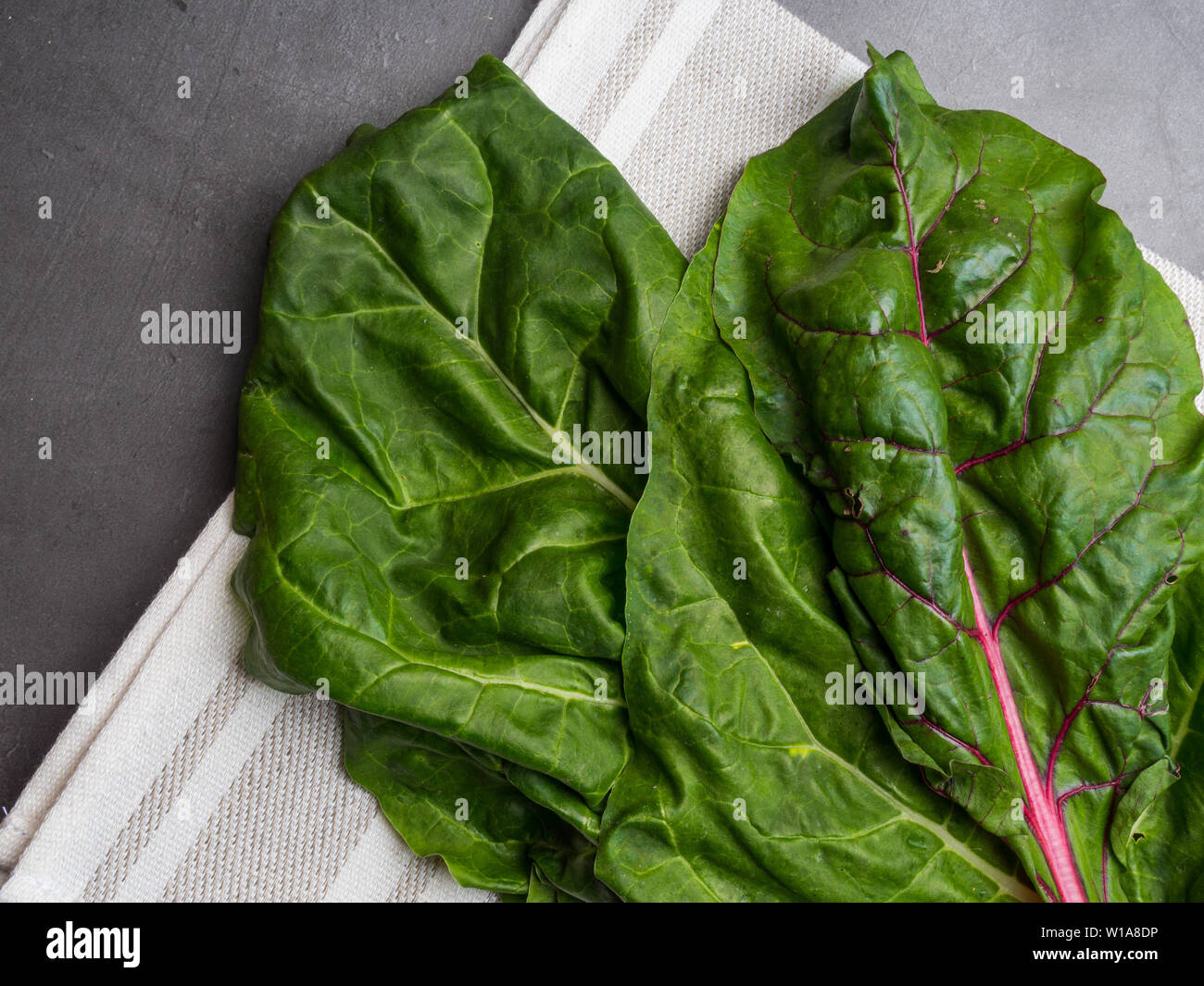 Fresh raw leaves of chard, mangold, swiss chard on a kitchen towel ...