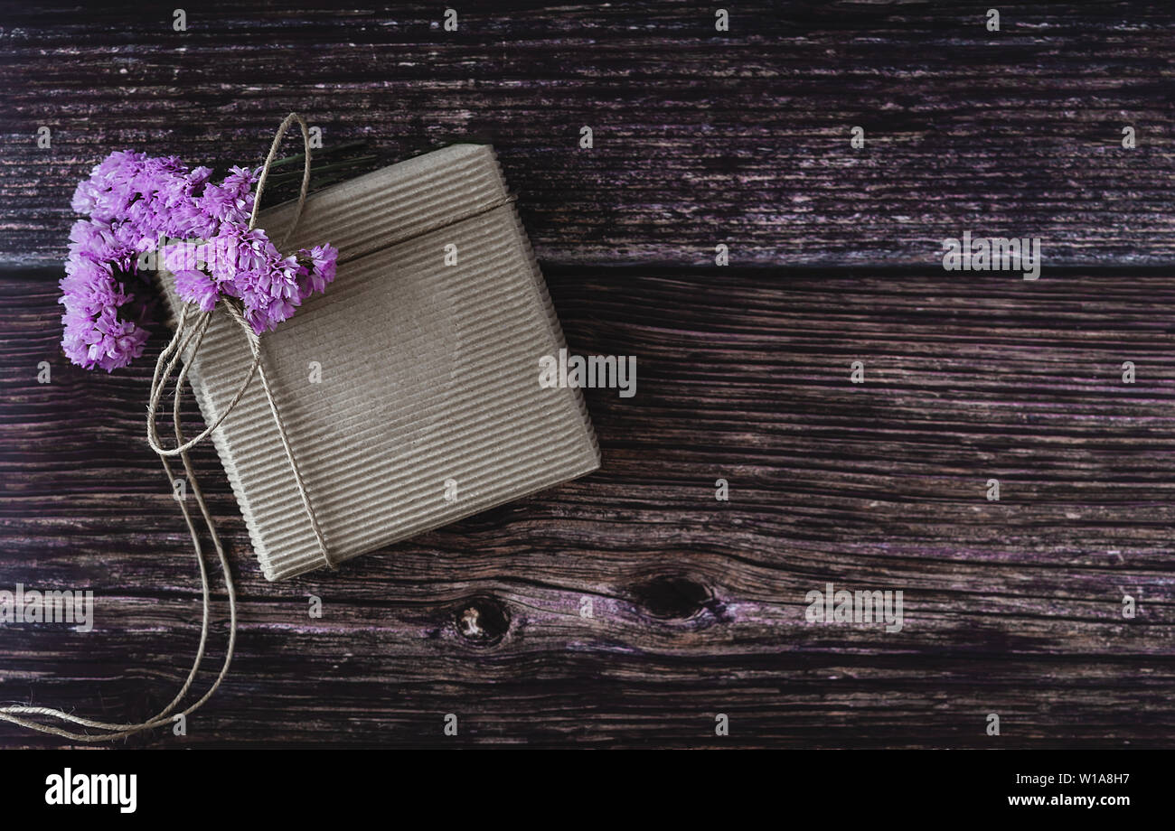 Handmade gift concept. Craft paper recycle gift box with flowers on ...