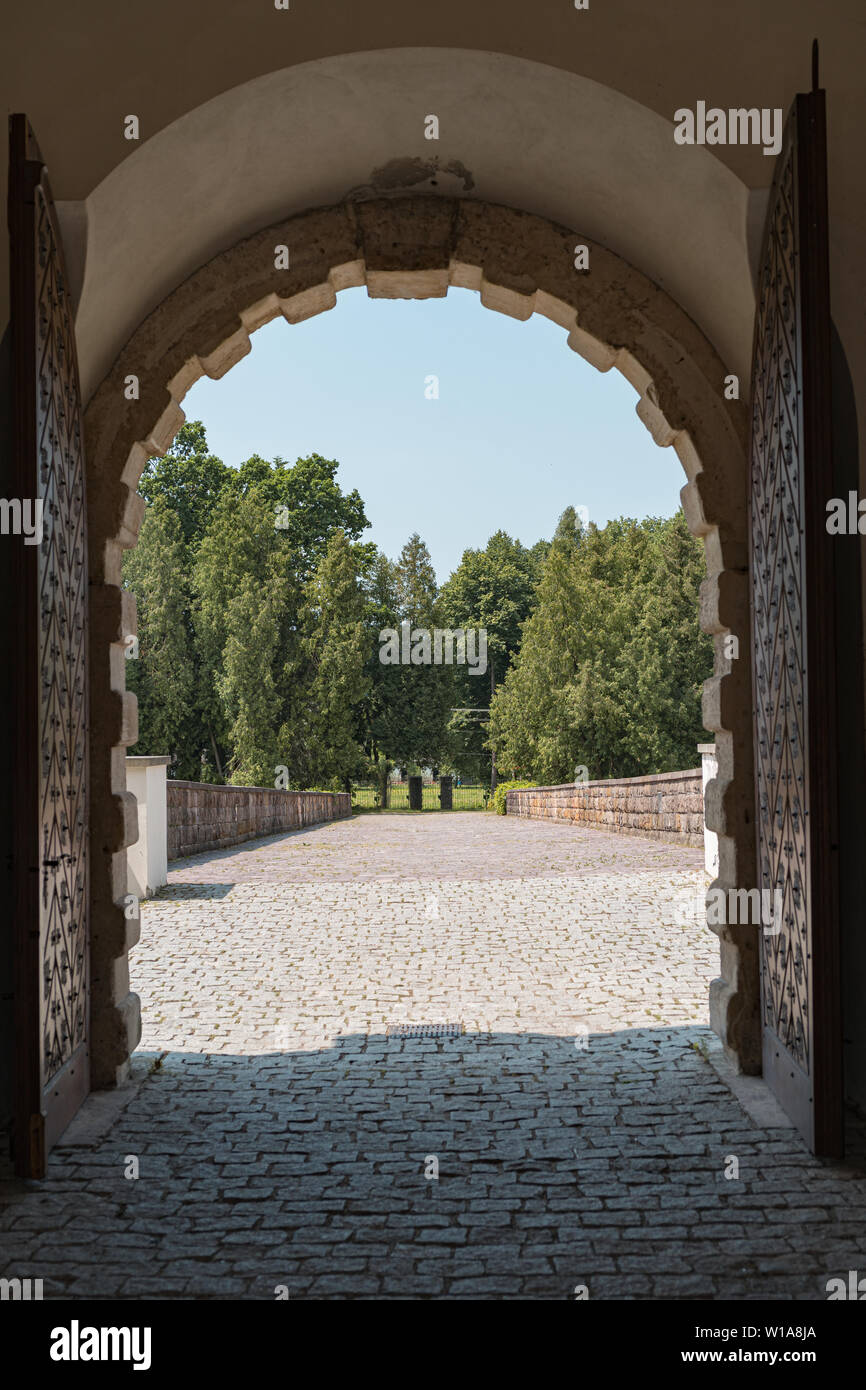 View on a castle grounds bridge through a late-renaissance entrance ...
