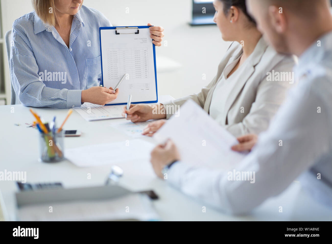 business team discussing report at office Stock Photo - Alamy