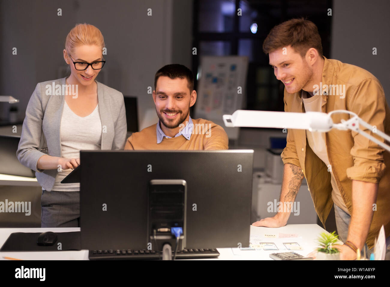 business team with computer working late at office Stock Photo - Alamy