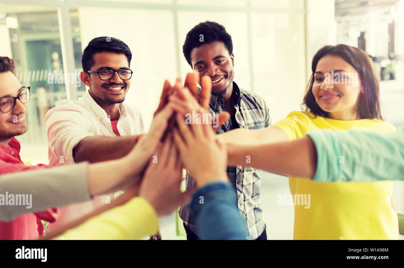 group of international students making high five Stock Photo - Alamy