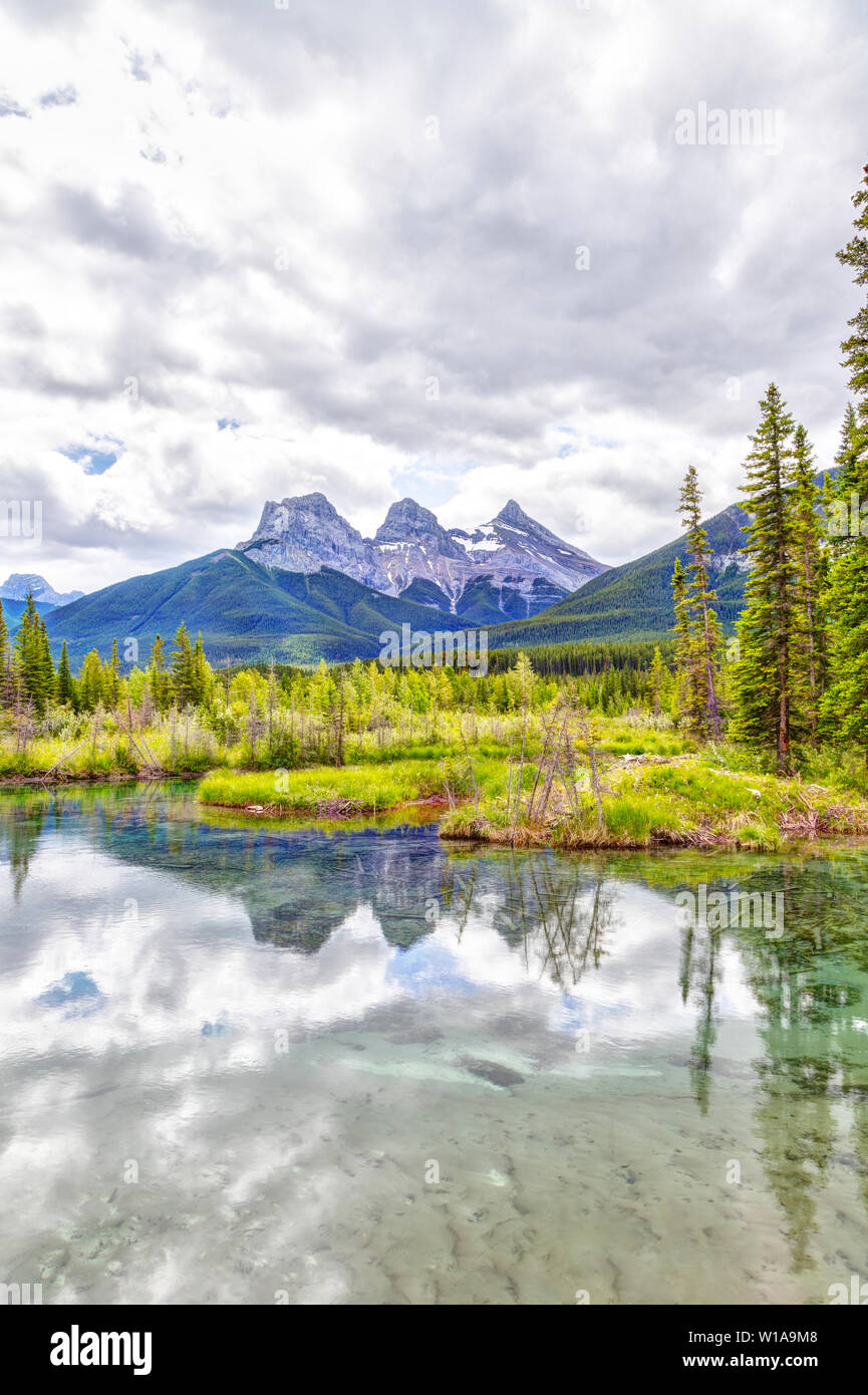 Canmore's famous Three Sisters mountain peaks and their reflections on ...