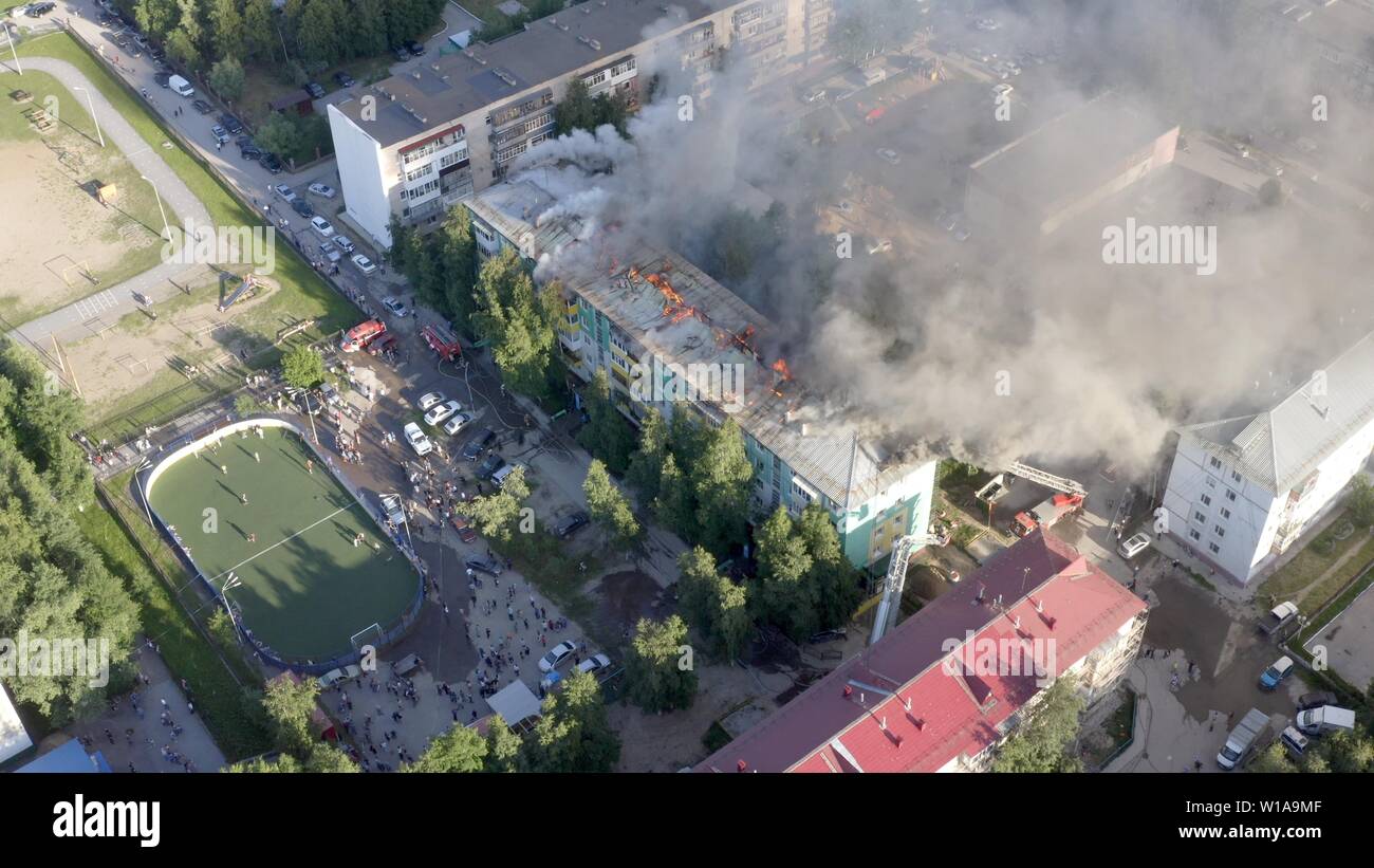 firefighters extinguish a fire on the roof of a residential highrise ...