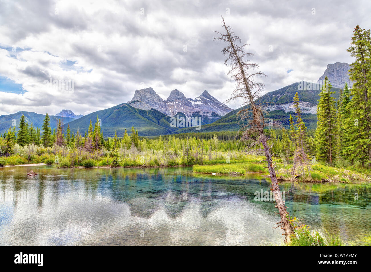 Canmore's famous Three Sisters mountain peaks and their reflections on ...