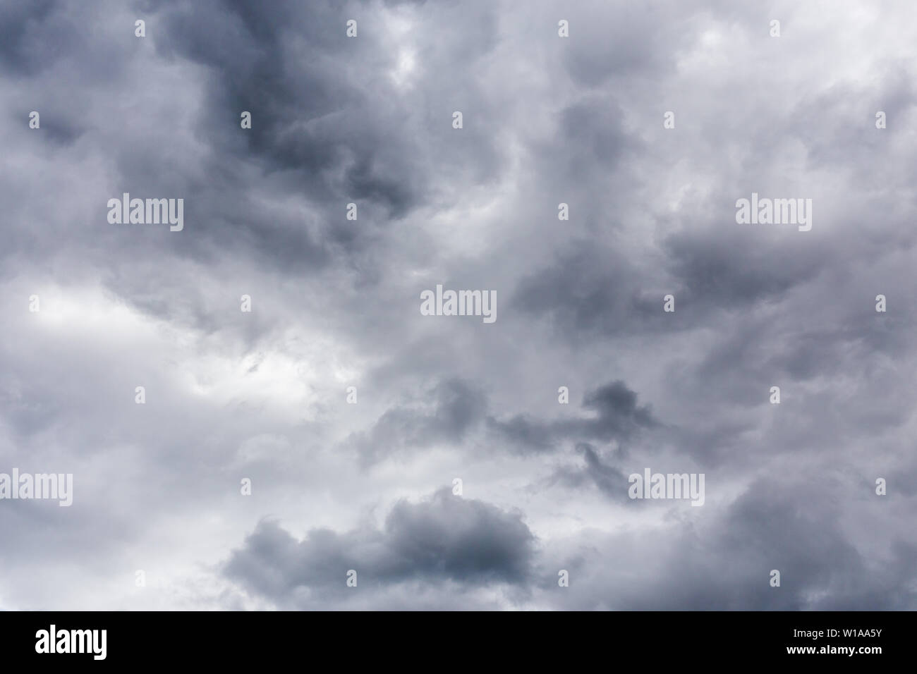 gray incoming storm clouds closeup backdrop, captured with telephoto ...