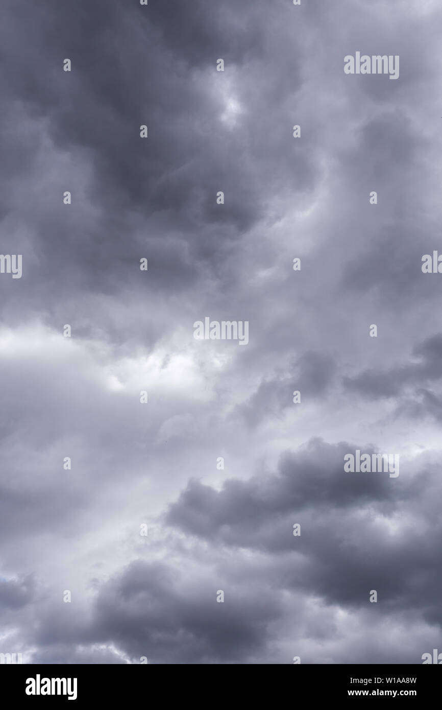 gray incoming storm clouds closeup backdrop, captured with telephoto ...