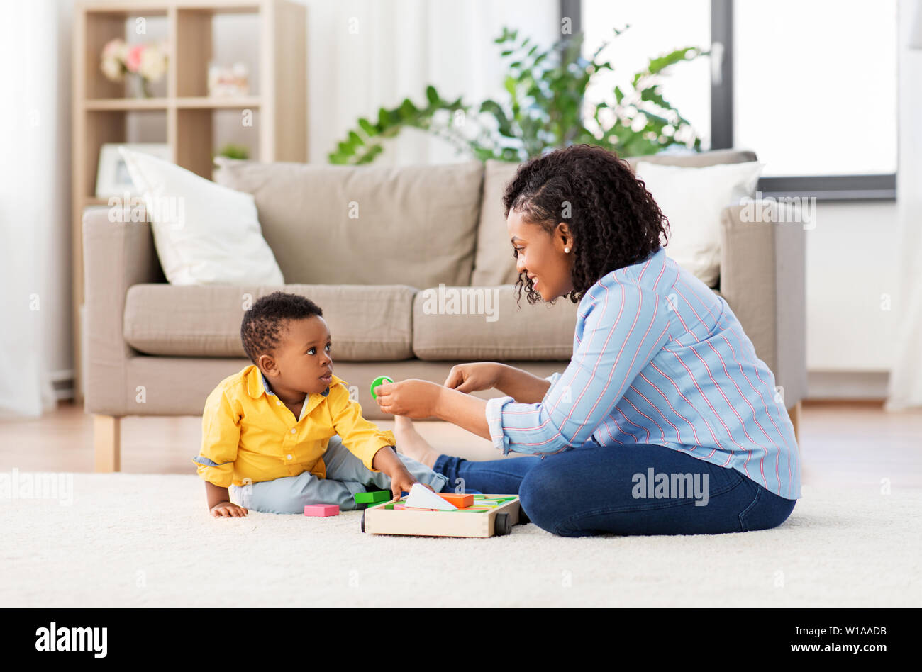 mother and baby playing with toy blocks at home Stock Photo - Alamy