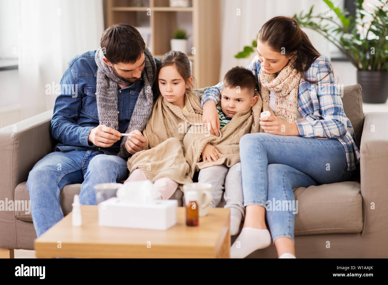 family with ill children having fever at home Stock Photo - Alamy