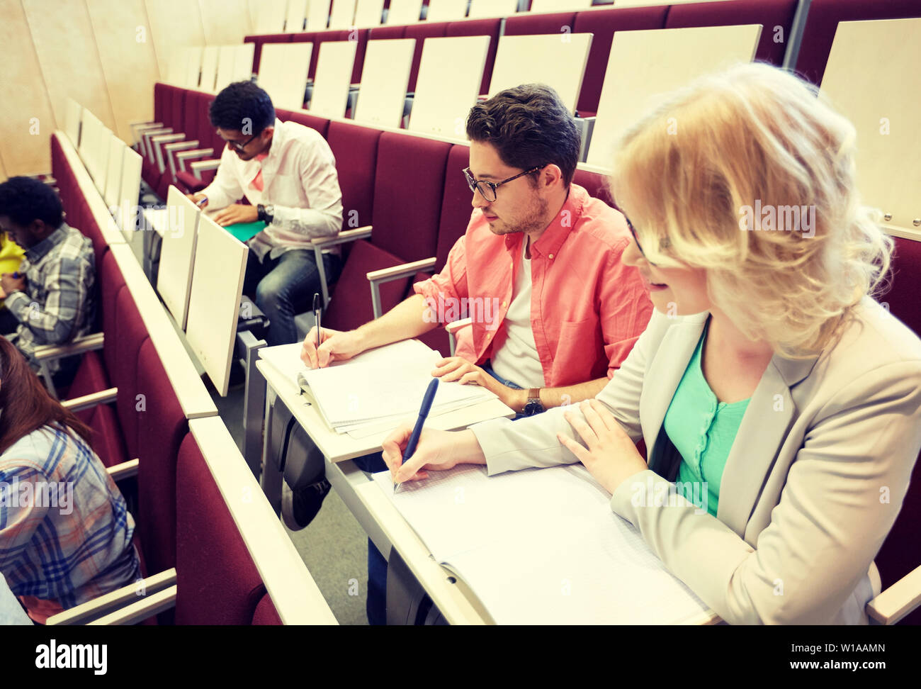 group of students with notebooks at lecture hall Stock Photo - Alamy