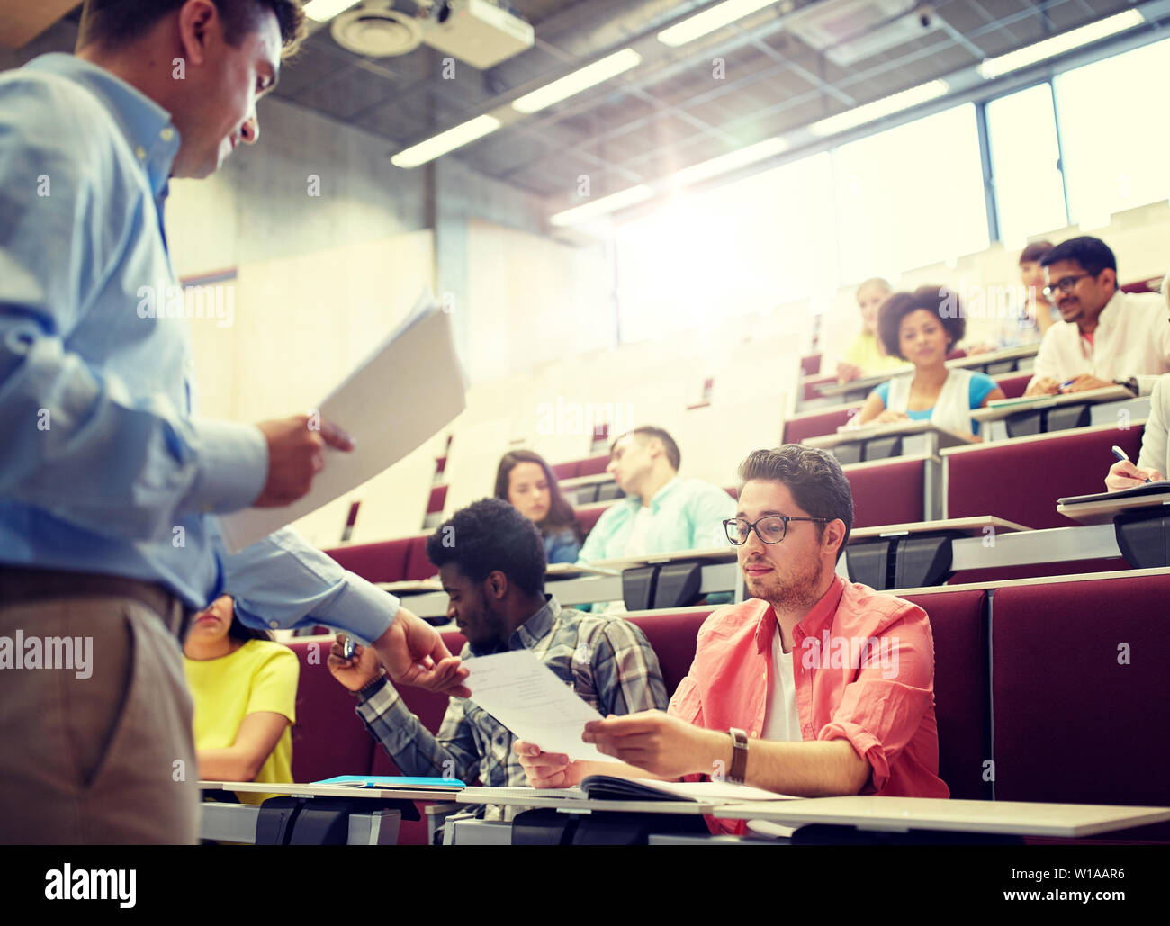 teacher giving tests to students at lecture Stock Photo - Alamy