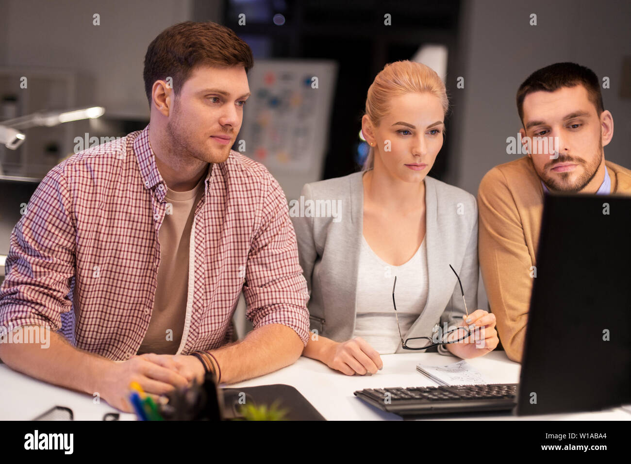 business team with computer working late at office Stock Photo - Alamy