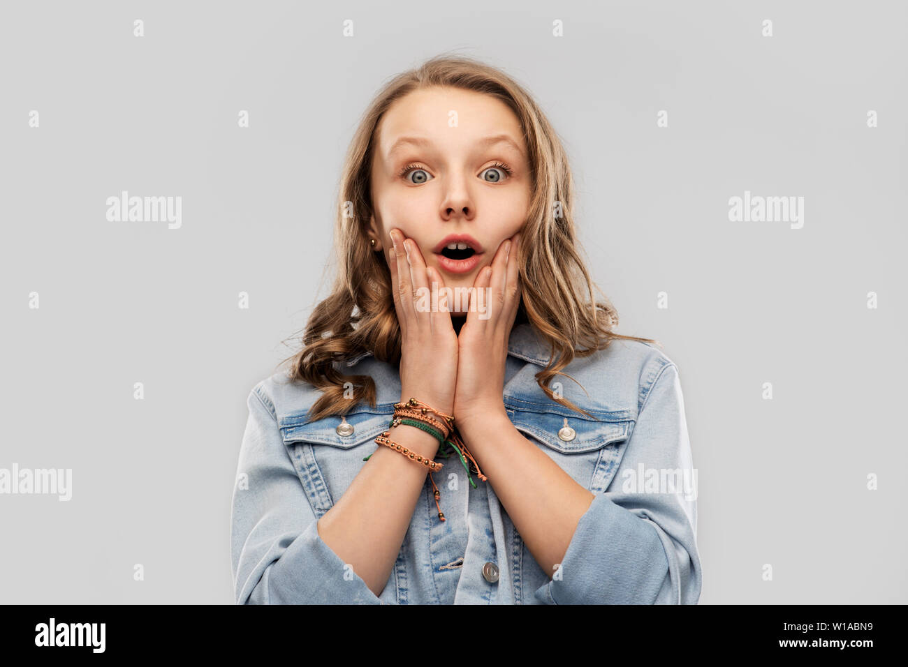 surprised or scared teenage girl in red t-shirt Stock Photo - Alamy