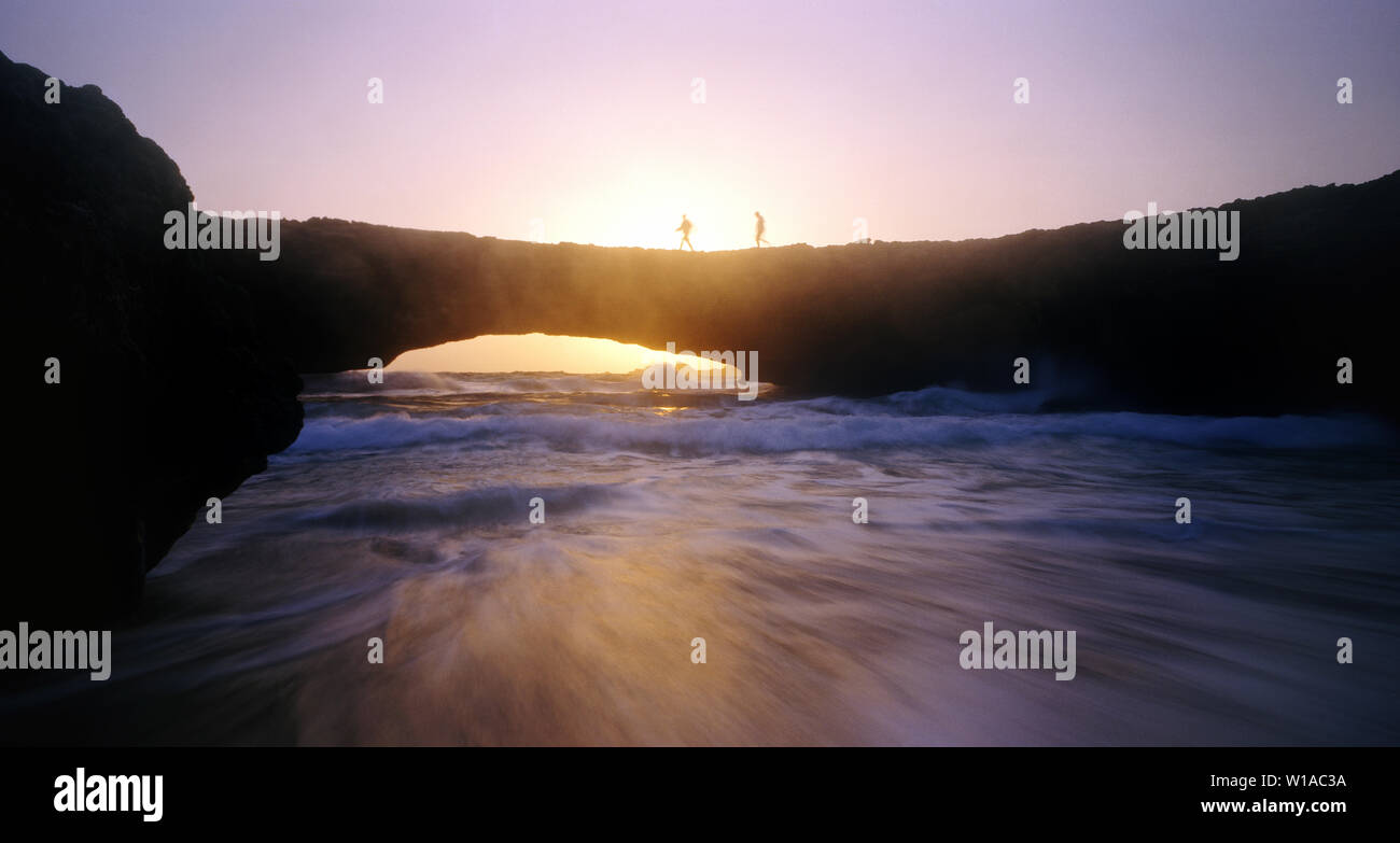 Bridge over sea with people walking at sunset Stock Photo - Alamy