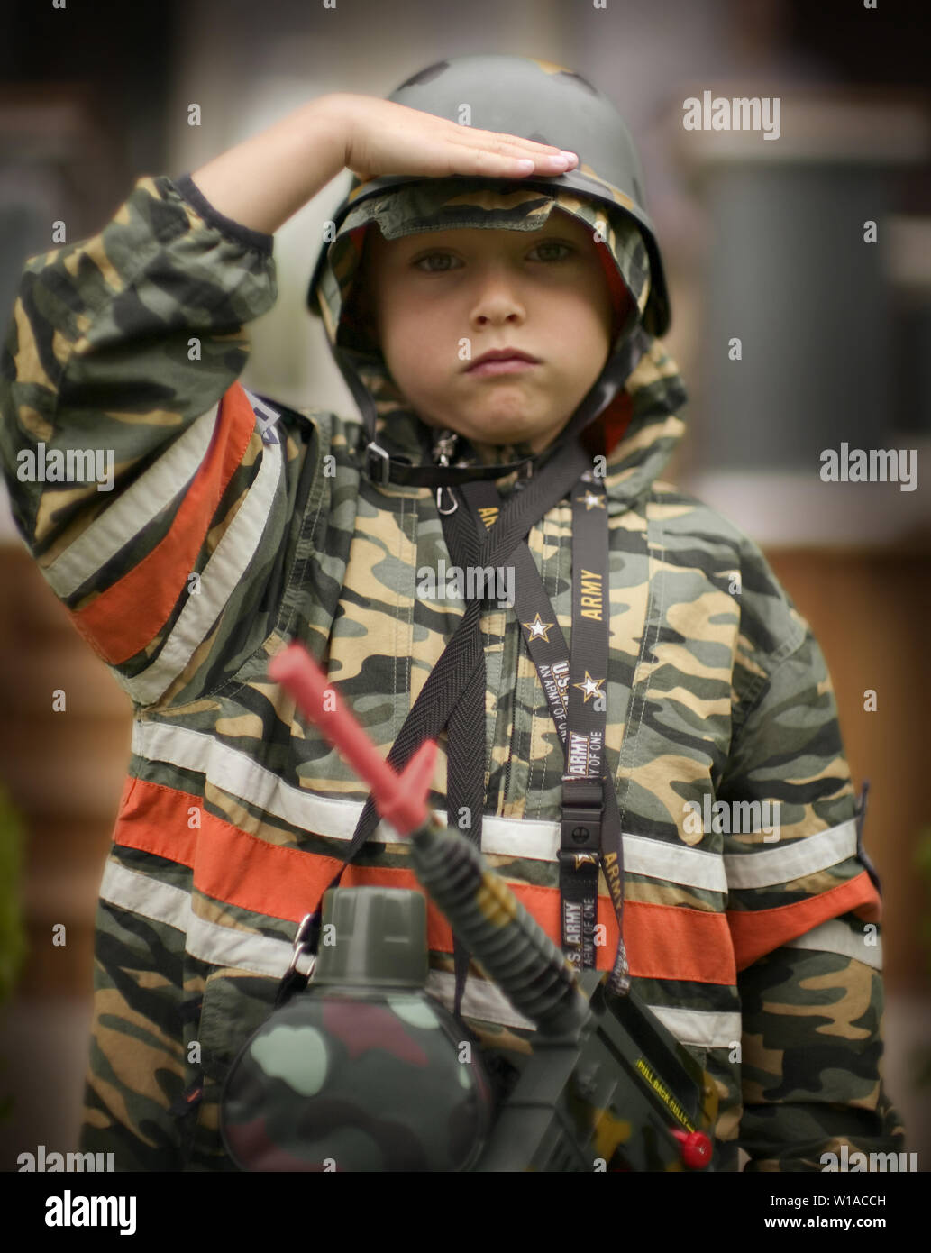Boy in Army outfit saluting Stock Photo - Alamy