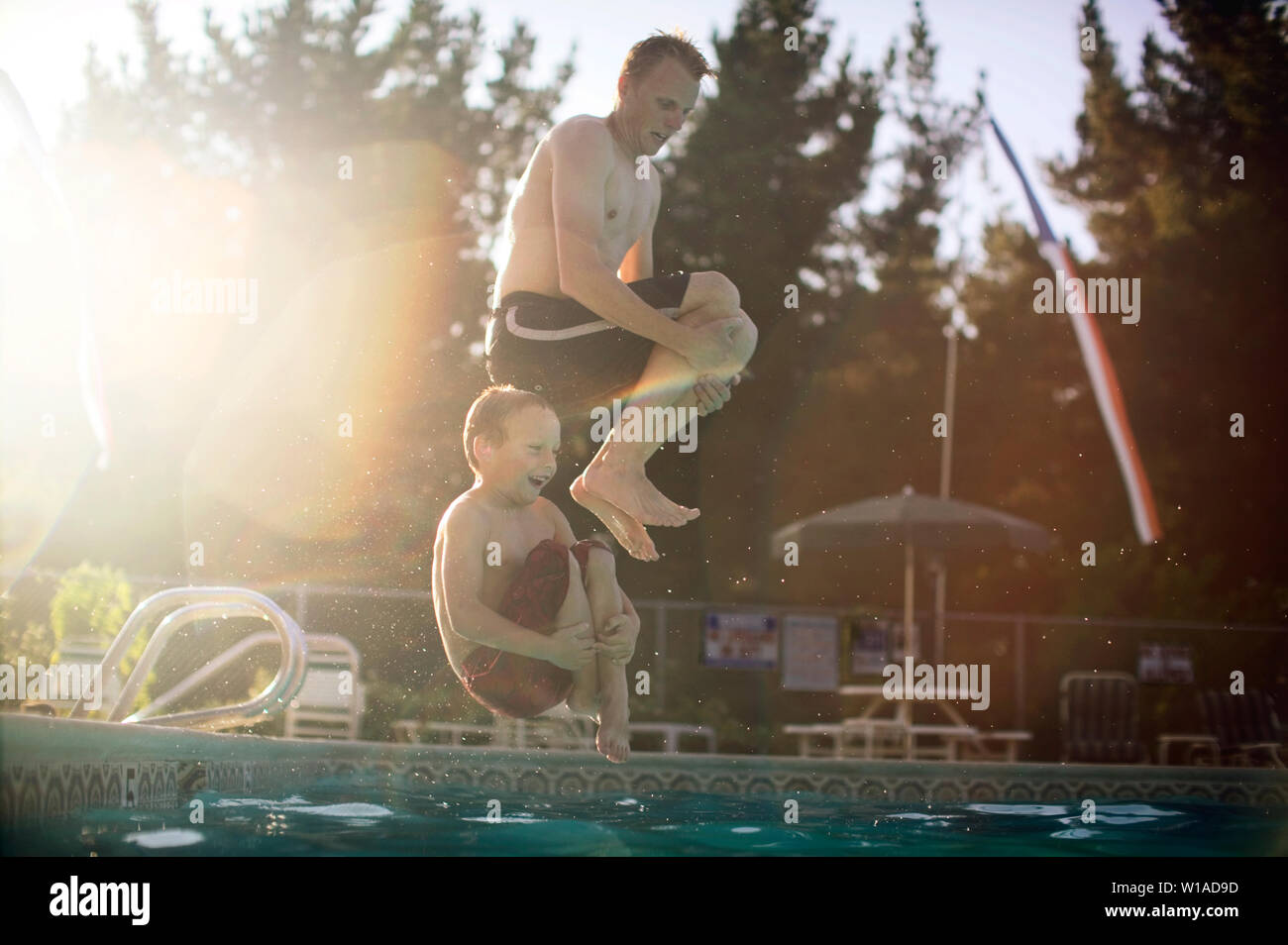 Two men jumping swimming pool hi-res stock photography and images - Alamy