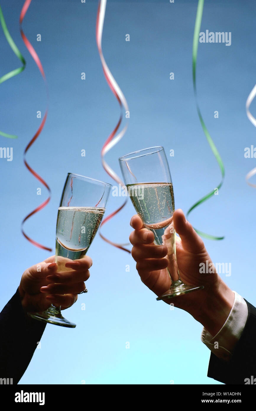Two people toasting with champagne in celebration Stock Photo - Alamy