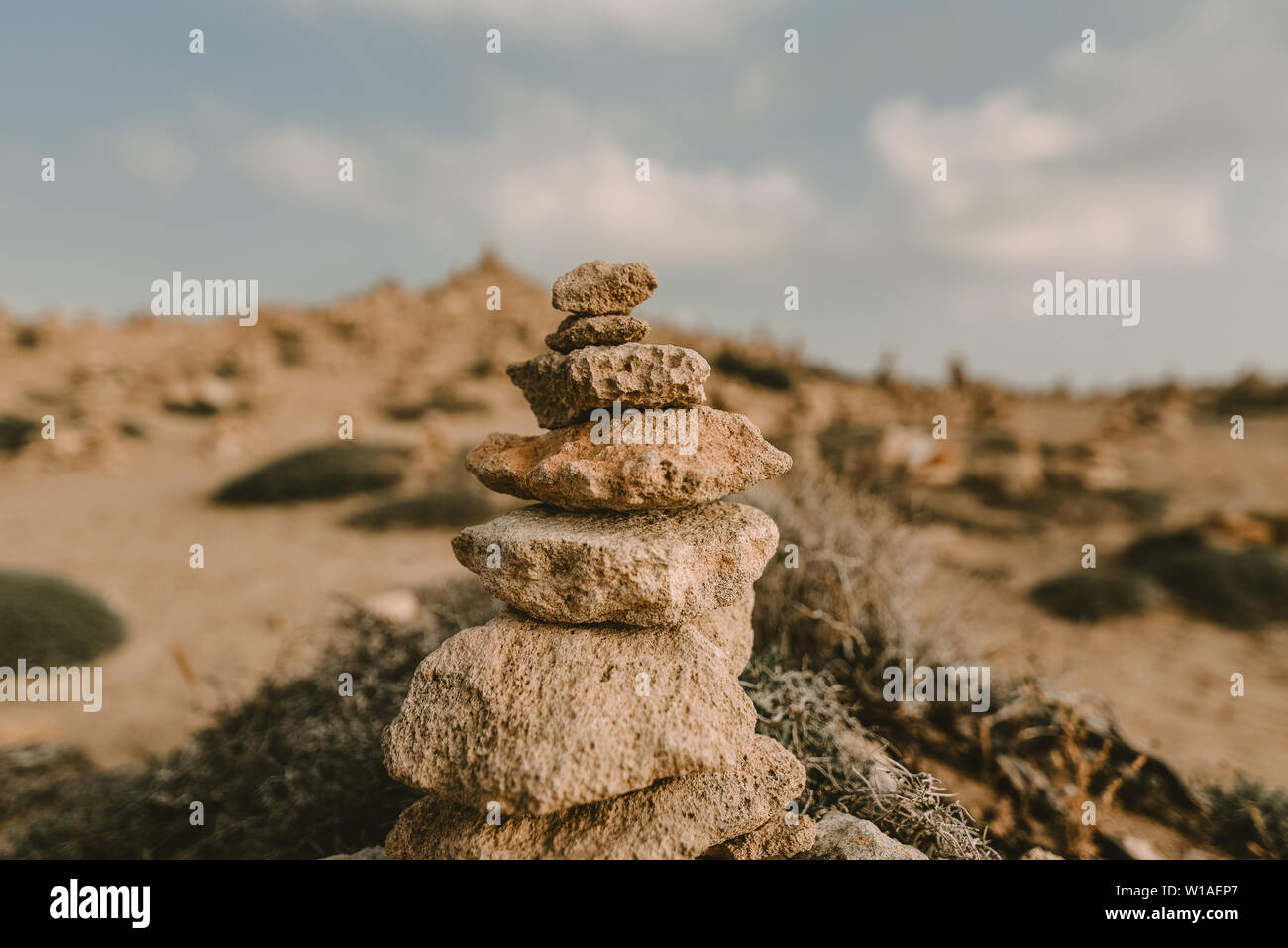Tower of rocks on beach. Small Zen out of pile of stones on rock. Tombs ...