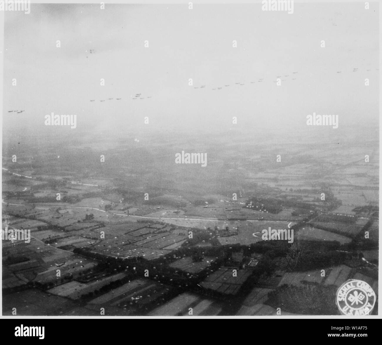 A fleet of Allied aircraft flies overhead as paratroopers of the Allied ...