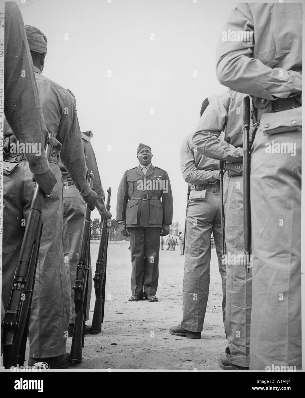 A platoon of Negro `boot recruits' listen to their drill instructor ...