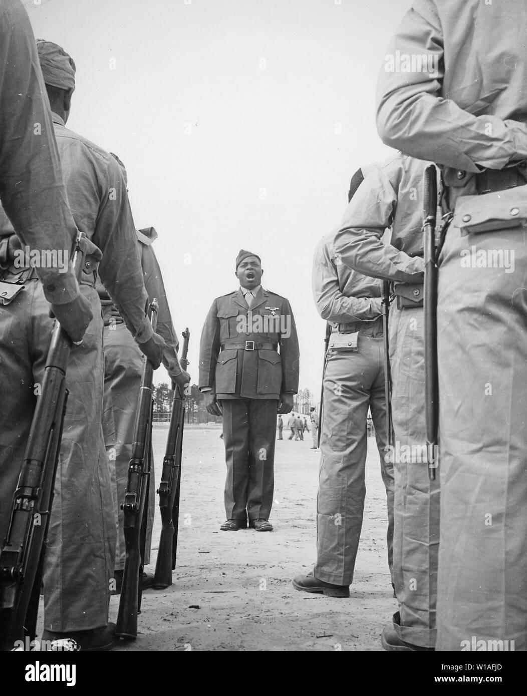 A platoon of Negro `boot recruits' listen to their drill instructor ...