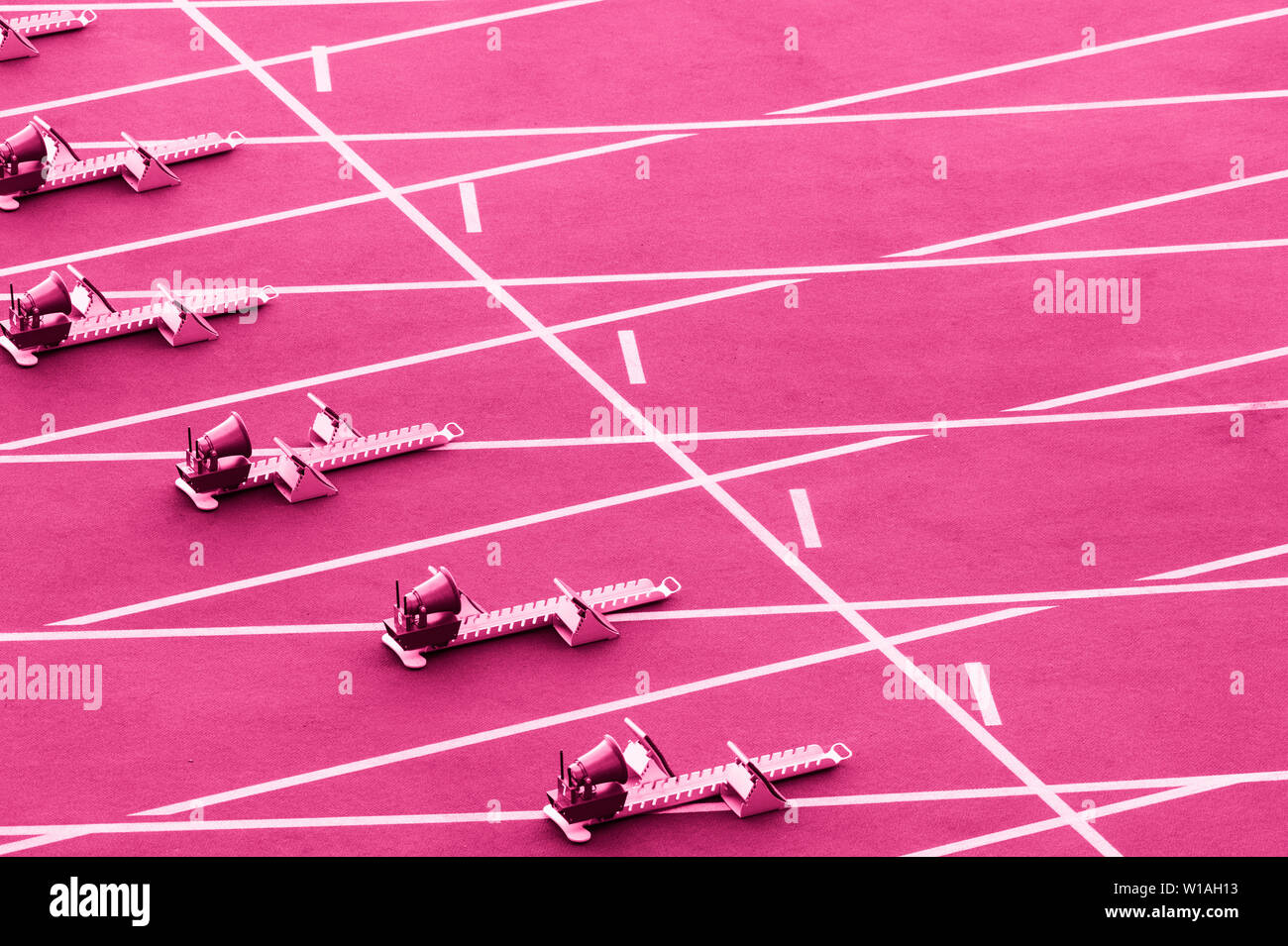 Starting blocks in track and field. Pink color filter Stock Photo - Alamy