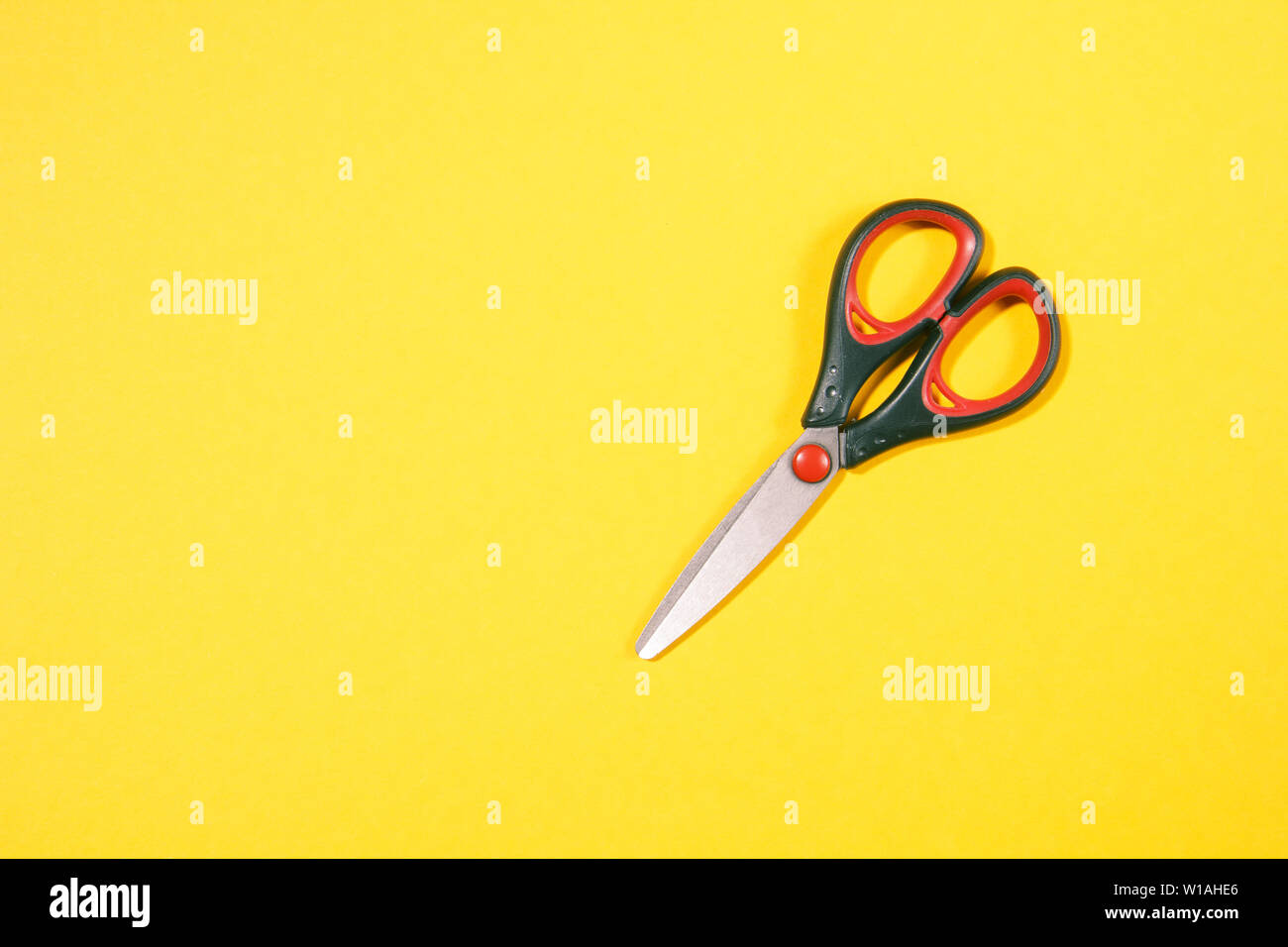 scissors on yellow background Stock Photo - Alamy