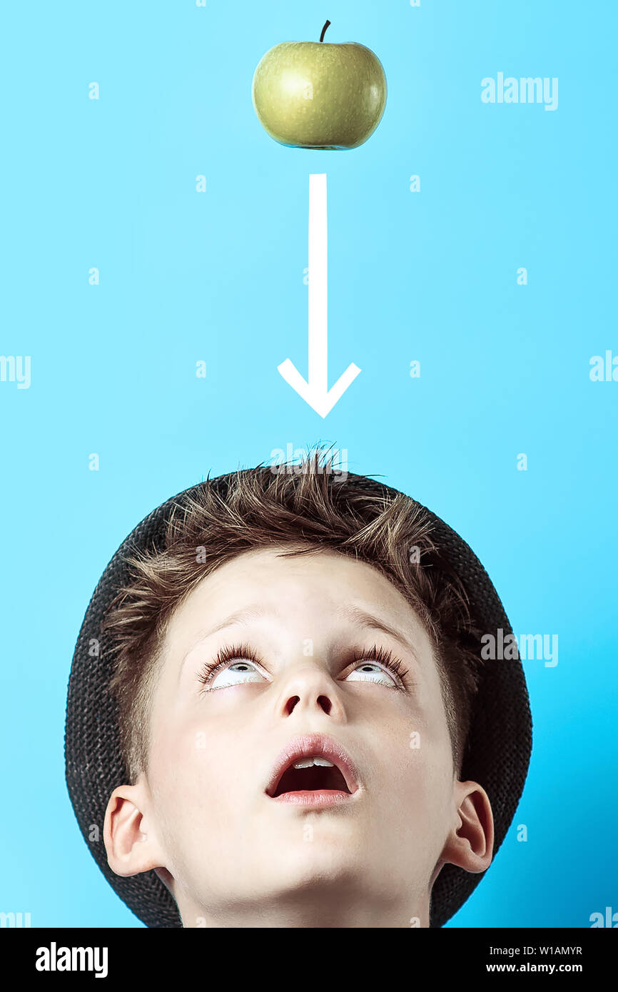 A surprised boy in a light shirt looks up. There on him falls green ...