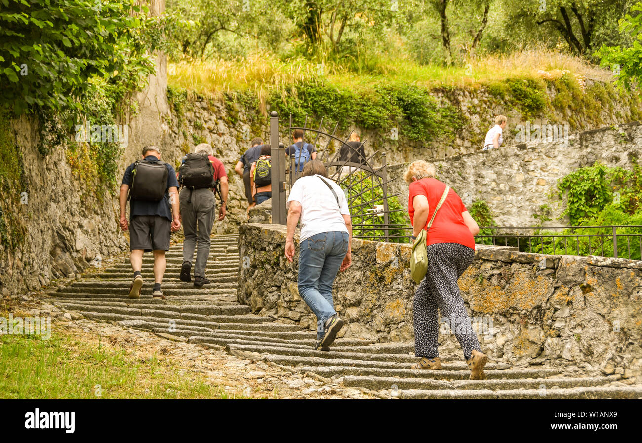 Woman walking up steep hill hi-res stock photography and images - Alamy