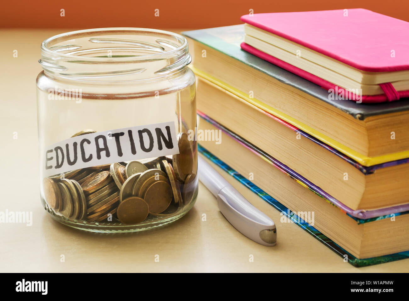 Pen and a few coins hi-res stock photography and images - Alamy