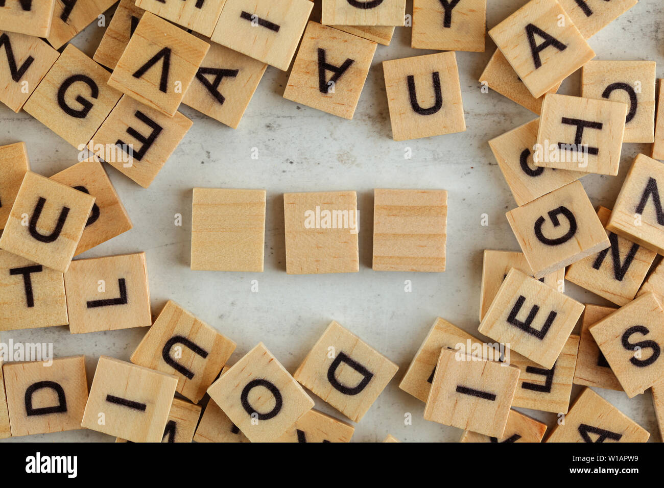 Top down view, pile of square wooden blocks with letters on white board ...