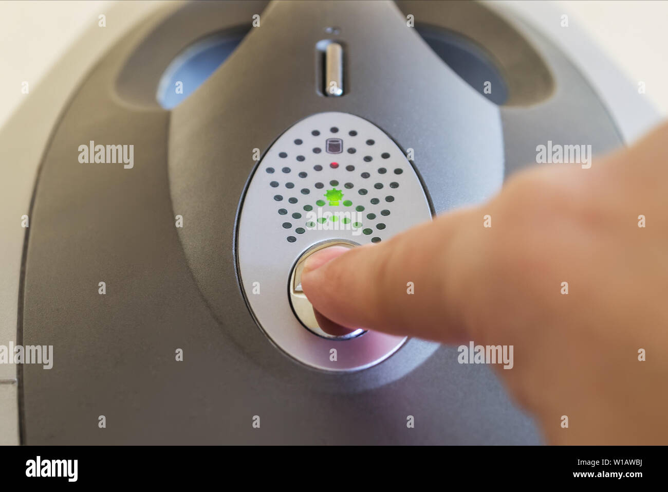 Finger is ready to push on Off button on the top of the personal ...