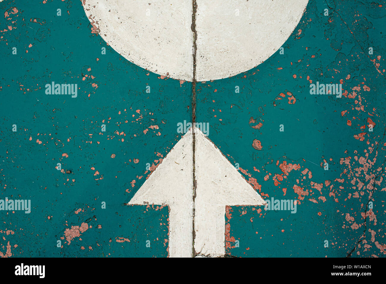 White arrow and circle painted on road. Symmetrical urban road signs on ...