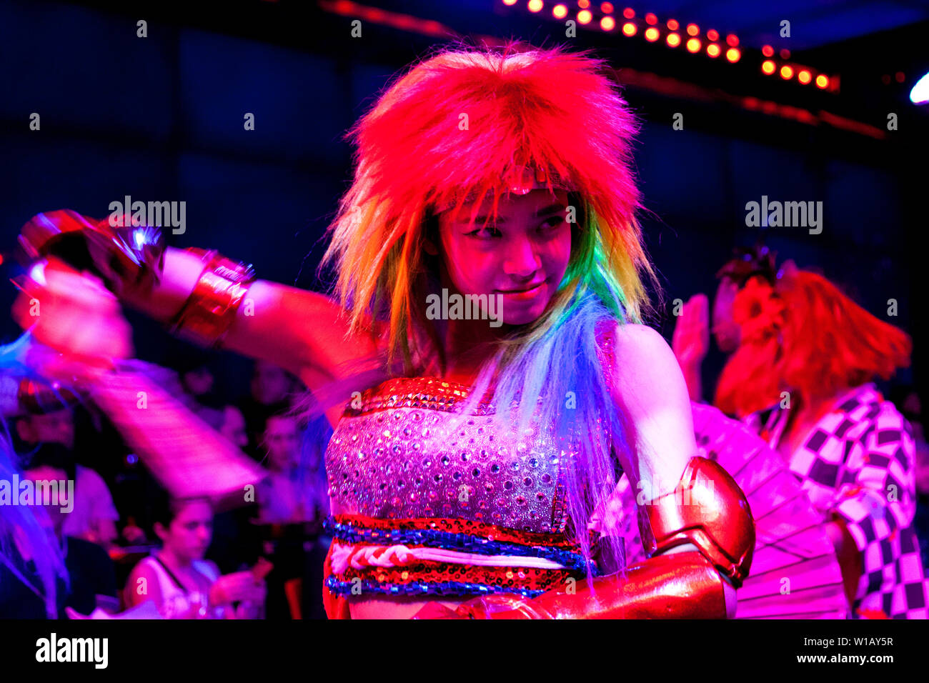 A Japanese dancer in a wig performing a show at the Robot Restaurant ...