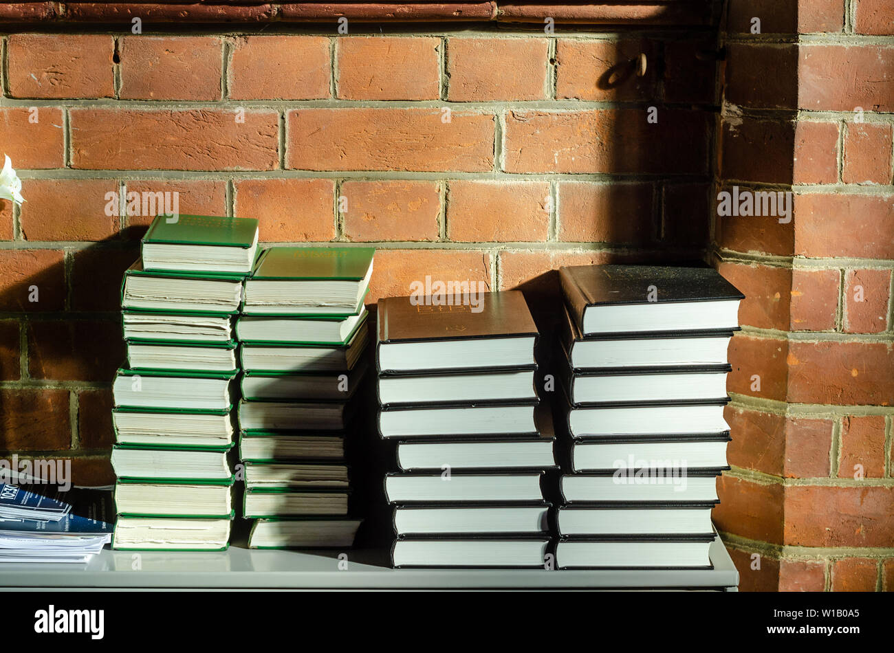 Stacks of bibles on a table in a church Stock Photo - Alamy