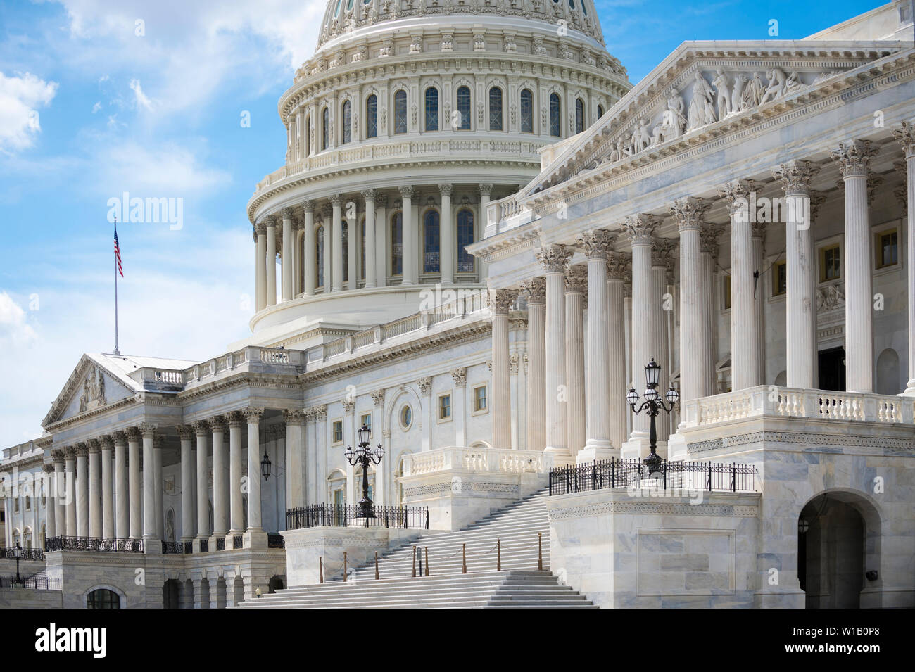 Afternoon view of the US Capitol Building under soft blue sky in ...