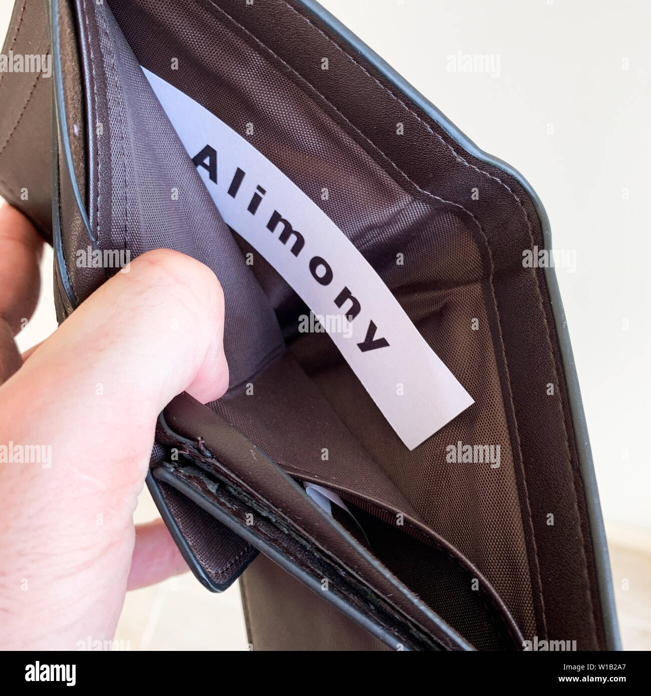 Payment alimony. Empty purse with card alimony Stock Photo - Alamy