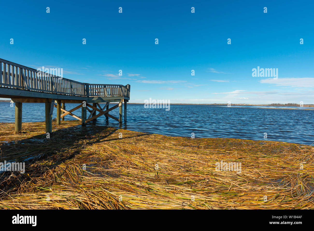 A dilapidated viewing platform over a Big Lake, a shallow prairie body ...