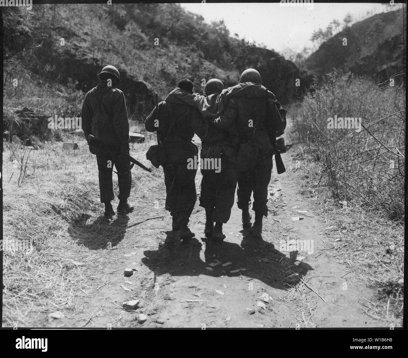 Buddies aid wounded man of 24th Infantry Regiment, after a battle 10 ...