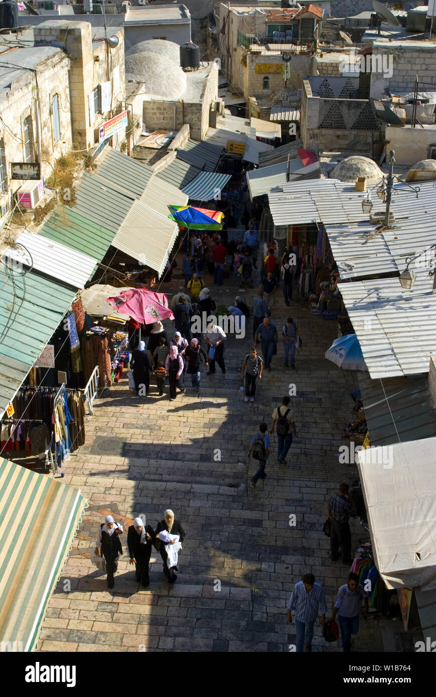 Narrow old street in Jerusalem top view. Walking people Stock Photo - Alamy