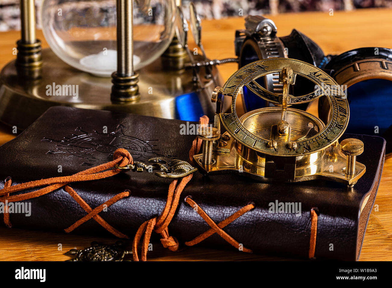 An Antique Brass Nautical Compass and Sundial, with a leather journal ...