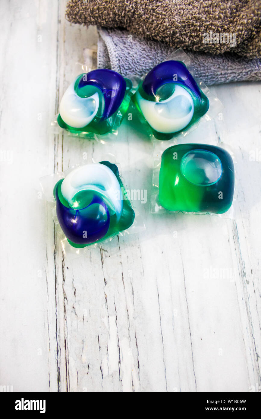 Laundry Day - laundry detergent pods on a laundry folding table with ...