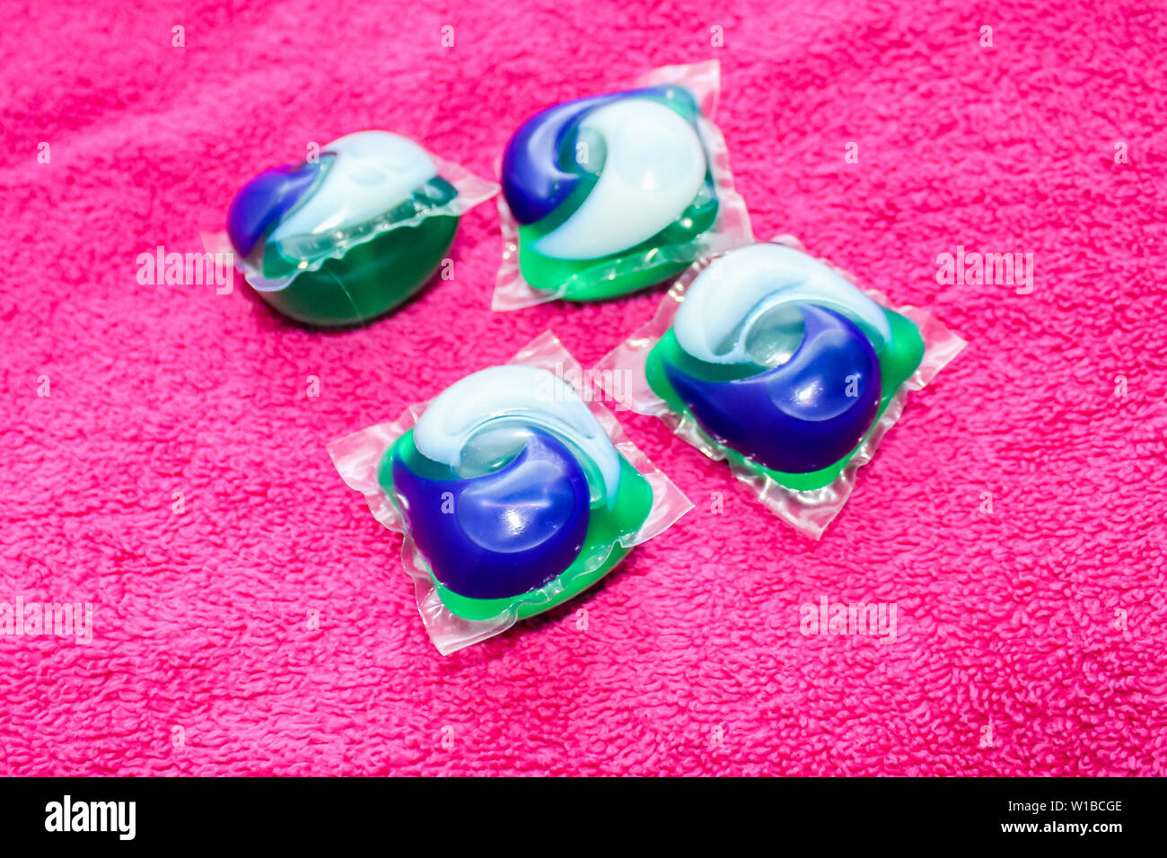 Laundry Day - laundry detergent pods on a laundry folding table with ...