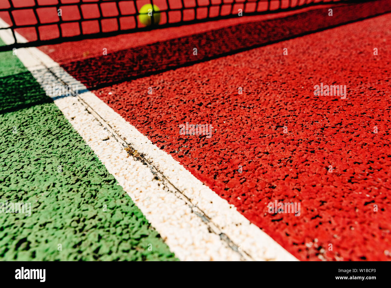 Background of a tennis net with a ball on the other side out of focus ...