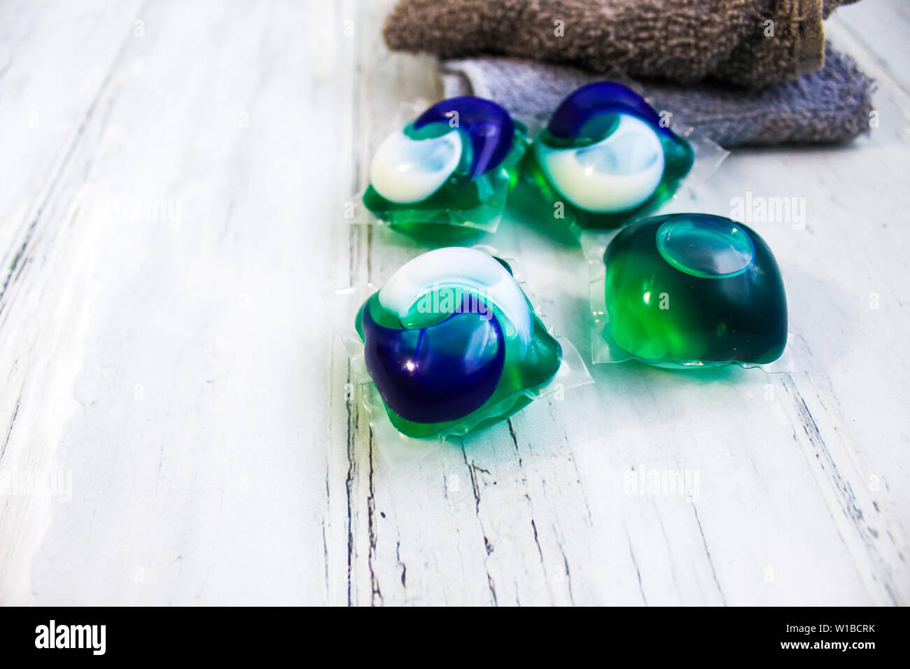 Laundry Day - laundry detergent pods on a laundry folding table with ...